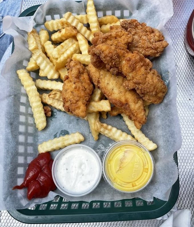 Crispy chicken tenders and crinkle-cut fries – proof that sometimes the simplest pleasures are the most satisfying, especially with two dipping sauces.