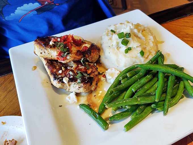Who knew a garage could produce such elegant fare? Perfectly grilled chicken alongside fluffy mashed potatoes and vibrant green beans.