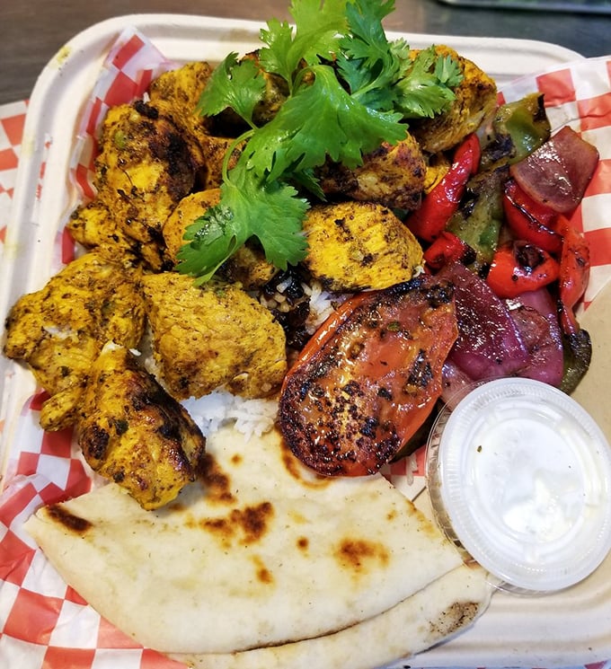 Sunshine on a plate! Saffron-kissed chicken kabob nestled on fragrant rice with grilled vegetables and warm pita – a vacation for your taste buds.
