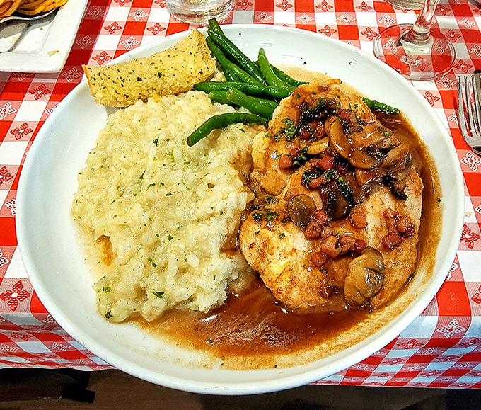 Chicken Marsala that's not afraid to swim in its sauce. The risotto soaks up that mushroom-wine goodness like it's been waiting all its life.