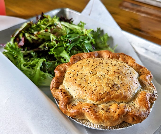 This chicken pot pie with its perfectly crimped edges isn't just comfort food—it's a warm hug served in an aluminum tin.