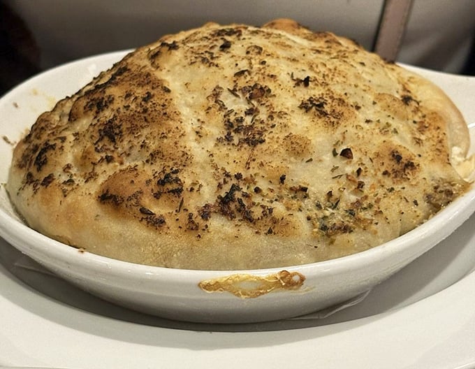 This chicken pot pie isn't just comfort food—it's a warm, herb-flecked hug under a golden dome of pastry perfection.