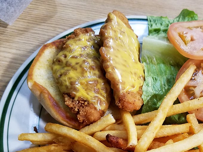 A golden-fried chicken sandwich nestled in a soft bun with melted cheese – proof that sometimes the simplest pleasures are the most satisfying.