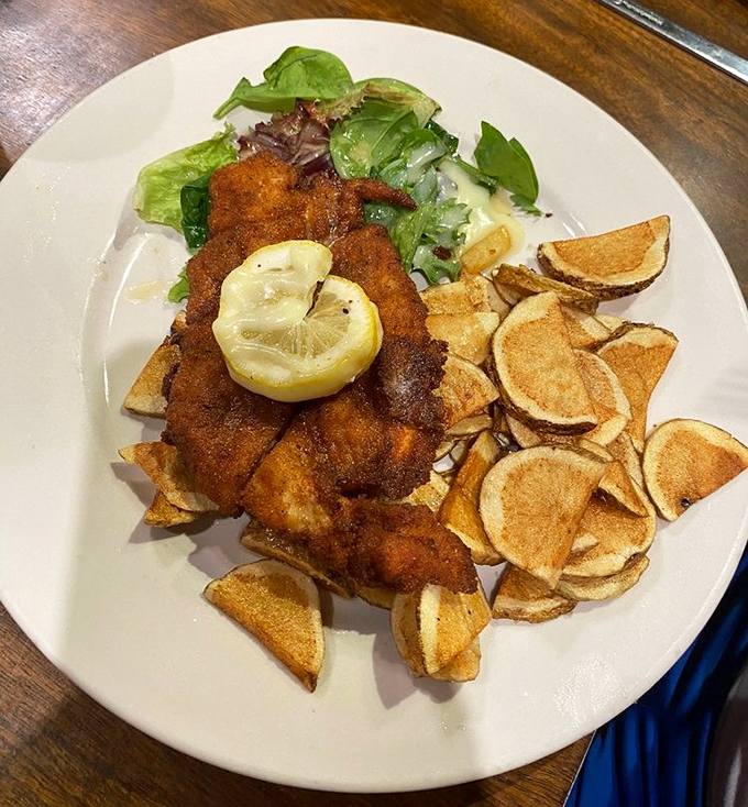 A perfectly breaded schnitzel with a squeeze of lemon that brightens the whole plate—crispy on the outside, tender within, like the best of us.