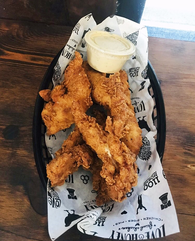 Golden-fried chicken tenders that shatter with each bite, served with a dipping sauce that deserves its own fan club.