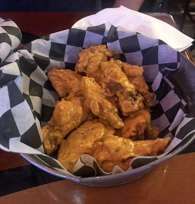 Wings that glow with that unmistakable Buffalo sheen – the kind that promises your taste buds a ticket to flavor town with no return trip planned.
