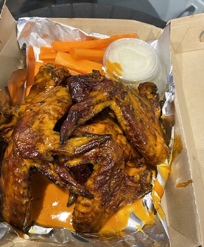 Wings that achieved their gorgeous mahogany color through patience and smoke, not some factory-made sauce bath.