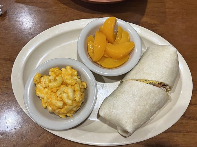 Comfort food in its travel outfit—a wrap that bundles all the good stuff with mac and cheese and peaches riding shotgun.