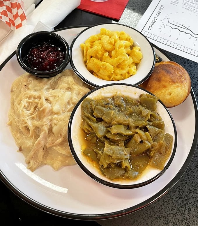 Southern comfort on a plate—chicken and dumplings, mac and cheese, and greens that have been simmering since your morning alarm went off.