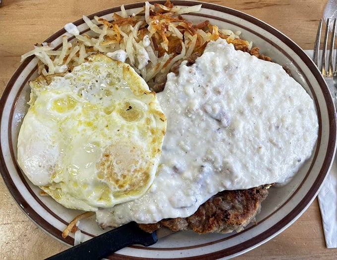 The chicken fried steak and eggs – where crispy, savory coating meets creamy country gravy in a breakfast romance that's lasted generations.