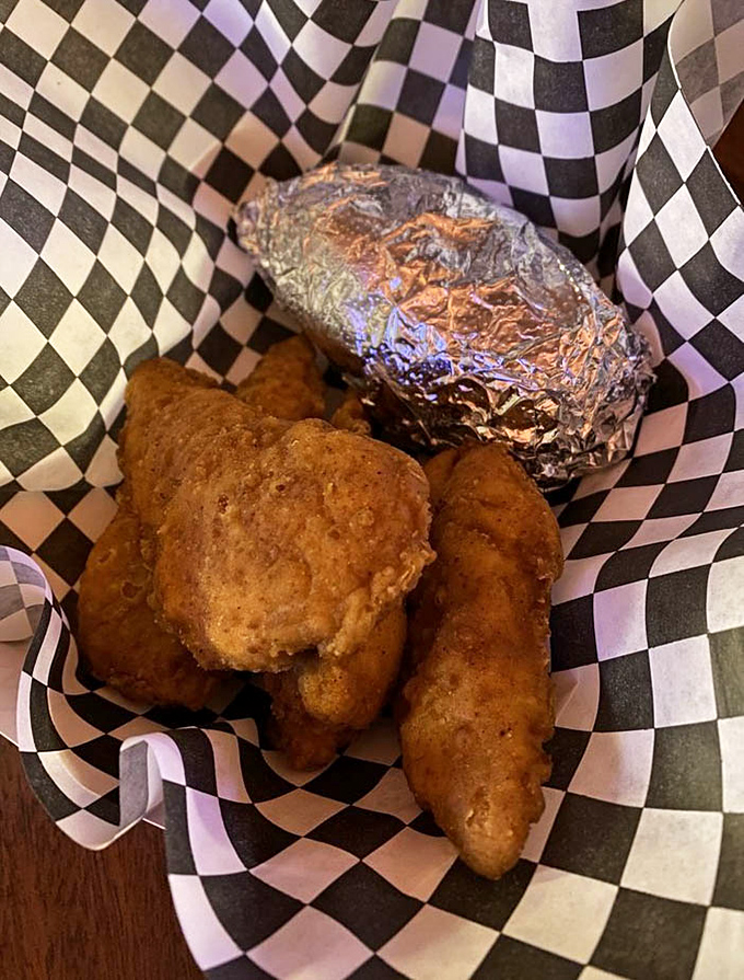 Comfort food doesn't need to be complicated – golden chicken tenders and a baked potato in a checkered basket that screams "you're going to enjoy this."