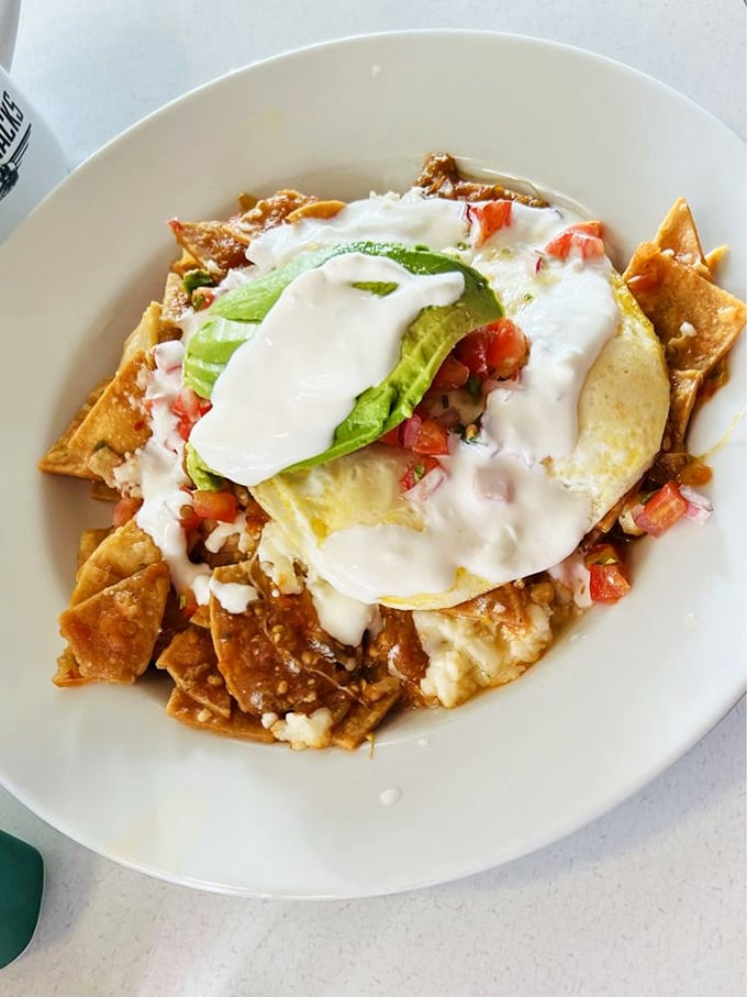 Chilaquiles that could heal a broken heart – crispy tortilla chips swimming in sauce, crowned with a sunny-side-up egg and avocado.