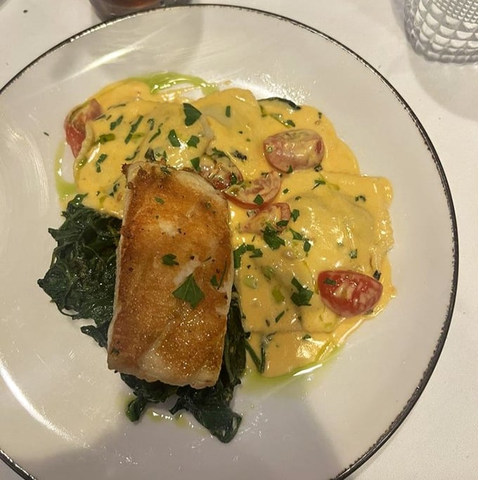 Chilean Sea Bass so perfectly seared it practically has its own fan club—perched atop spinach like royalty surveying its delicious kingdom.