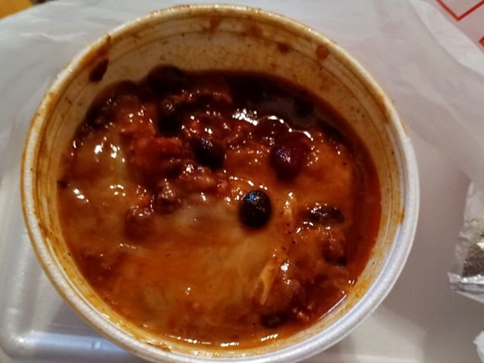 Bean-studded chili that's clearly been simmering with purpose. The steam rising isn't just heat—it's aromatic evidence of low-and-slow dedication.