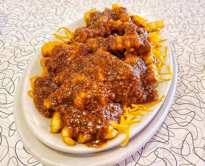 Chili cheese fries—where potatoes fulfill their highest calling by becoming vessels for that signature Cincinnati-style chili and melted cheese.