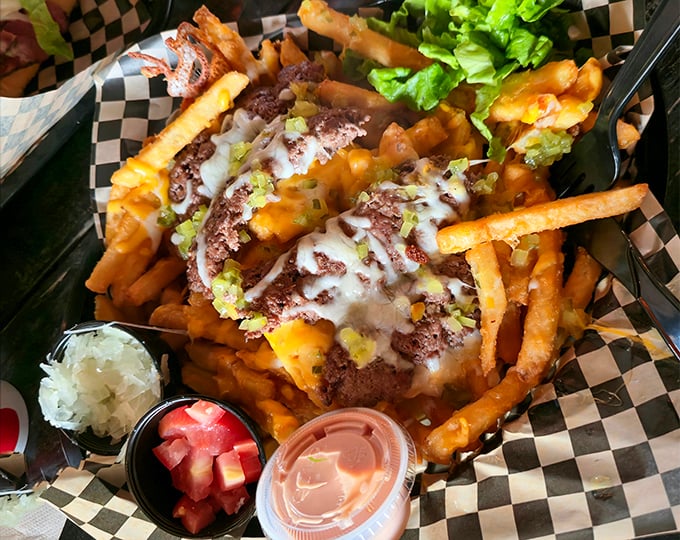 These aren't just any chili cheese fries – they're a mountain of crispy potatoes transformed into a knife-and-fork adventure worth every calorie.