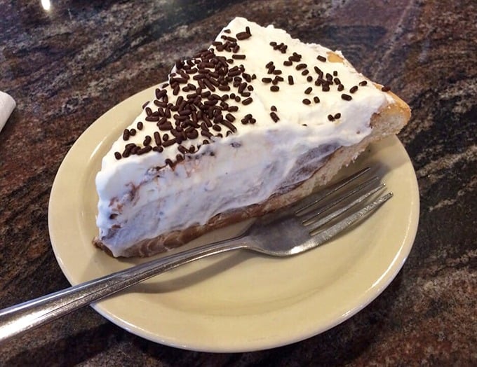 This chocolate cream pie doesn't need fancy garnishes or pretentious plating—just an honest-to-goodness flaky crust, silky filling, and a mountain of real whipped cream.