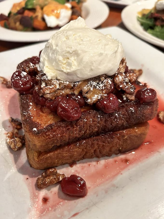 French toast that makes you question every other breakfast you've ever had. Those cherries and cream aren't just toppings – they're a life philosophy.
