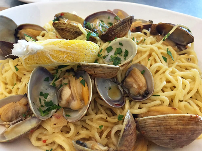 Linguine with clams—where pasta meets ocean. Those shells aren't just decoration; they're little treasure chests delivering briny surprises with each twirl of your fork.