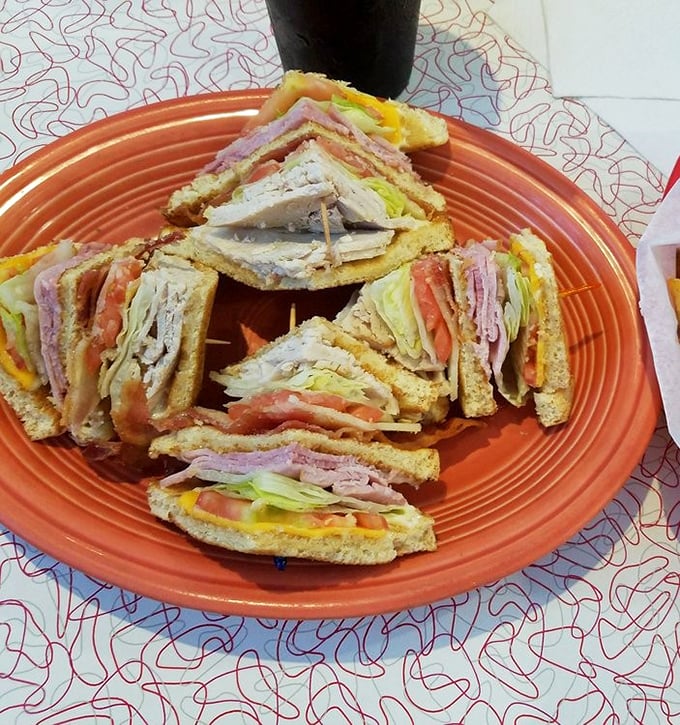 The club sandwich at Mary's doesn't just stack ingredients—it builds a skyscraper of turkey, ham, and bacon that requires engineering skills just to eat.