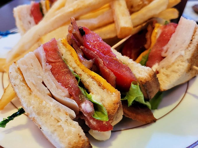 A club sandwich stacked higher than my weekend reading pile. Those crisp layers tell a better story than most bestsellers.