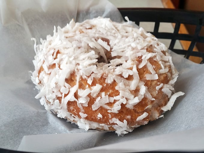 The coconut donut doesn't just wear its tropical coating—it flaunts it like a tiny, circular snowball of sweetness.