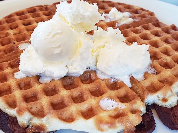 This waffle doesn't just have perfect squares—it has perfect engineering, with crisp edges giving way to fluffy interior. The butter melts in slow-motion glory.