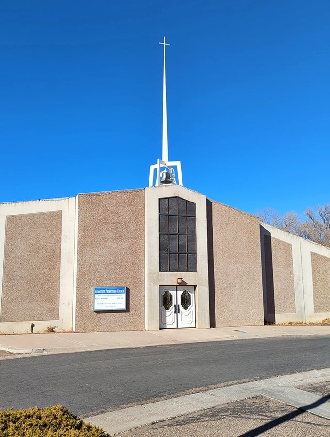 The Community Presbyterian Church's striking modernist design reaches skyward with its dramatic spire, a spiritual landmark against Arizona's brilliant blue heavens.