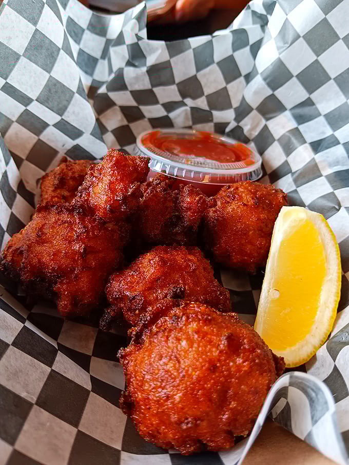 These conch fritters look like they've been kissed by the fryer gods – crispy, golden-brown orbs of Florida tradition served with a side of sass.
