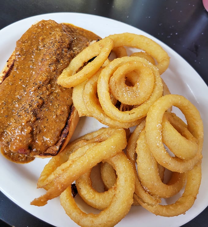 Meatloaf with onion rings—a partnership so perfect it makes you wonder why more diplomatic negotiations don't happen over plates of comfort food.