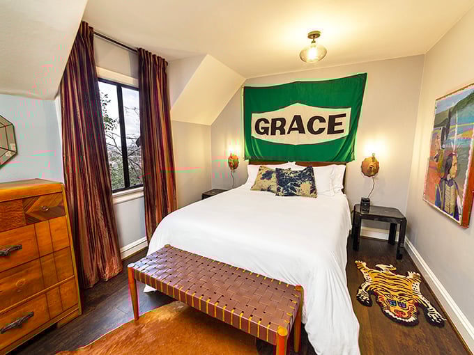 This bedroom's quirky charm comes with a side of personality—where else would you find a vintage gas station sign serving as unexpected headboard art?