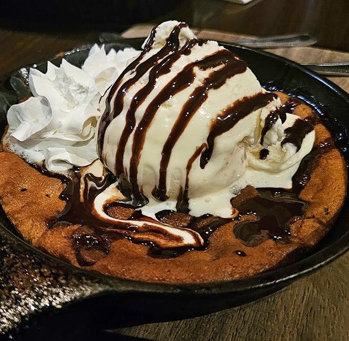 The skillet cookie sundae arrives like a warm hug after a long day—melting ice cream creating rivers of vanilla through valleys of chocolate. Spoons ready for battle!