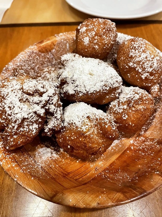 These powdered sugar-dusted corn fritters aren't just dessert—they're little orbs of joy that make you wonder why you ever wasted calories elsewhere.