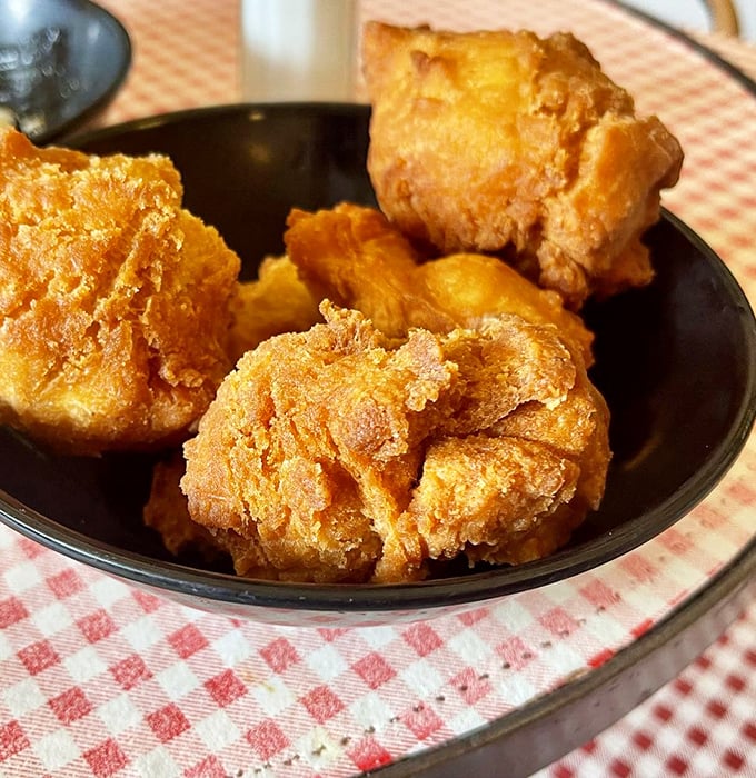 Corn fritters that look like golden nuggets of happiness, begging to be dunked in whatever sauce they're offering.