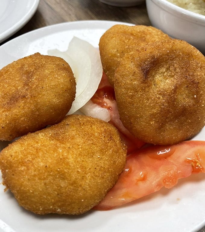 These golden discs of cornbread aren't just side dishes—they're essential tools for sopping up every last drop of gravy.