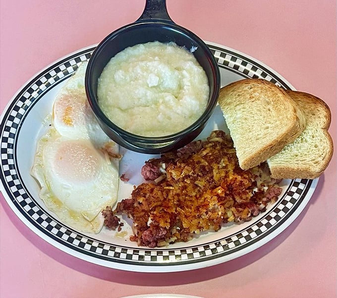 Crispy corned beef hash with sunny-side-up eggs and grits—the breakfast equivalent of hitting three cherries on a slot machine.