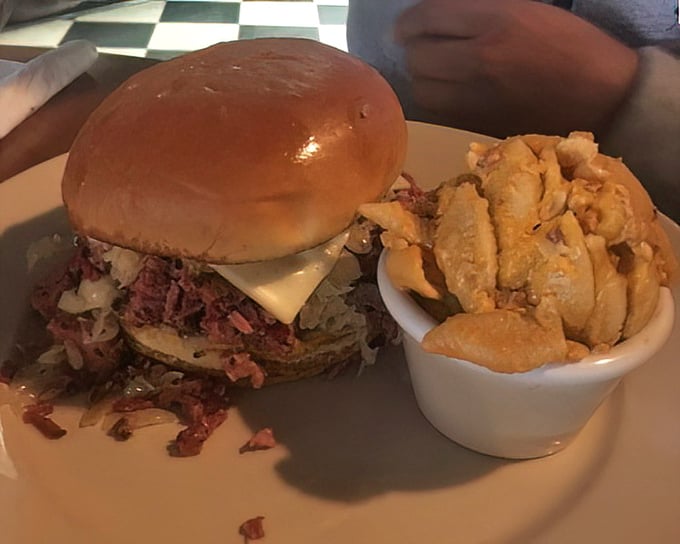 A sandwich that requires both hands and a strategy – note how the meat peeks out, practically winking at you with smoky promise.