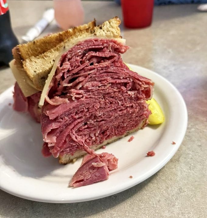 Behold the cross-section of a proper corned beef sandwich—where "generous portion" becomes a hilarious understatement.