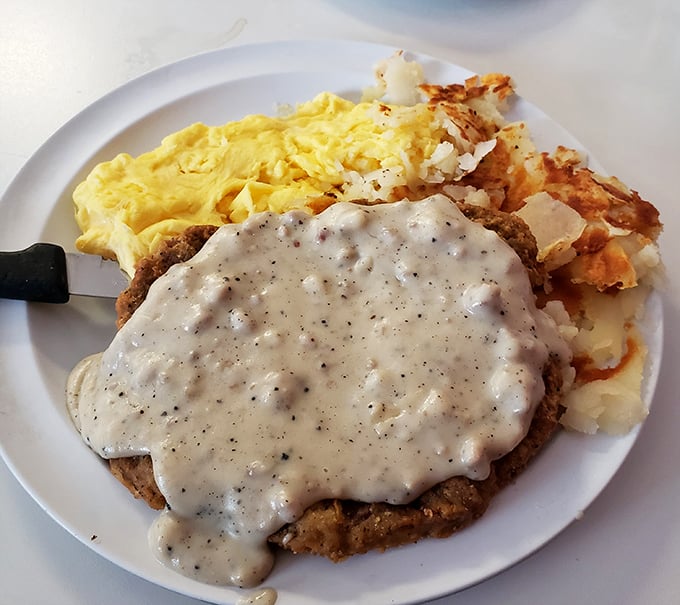 Country fried steak smothered in gravy so good you'll want to write poetry about it—or at least lick the plate when nobody's looking.