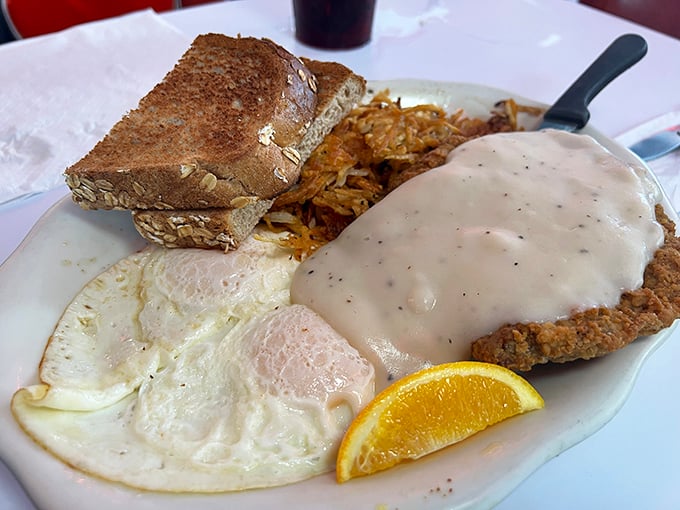 Country fried steak smothered in peppery gravy with eggs sunny-side up—a breakfast that fuels Florida adventures or justifies afternoon naps.