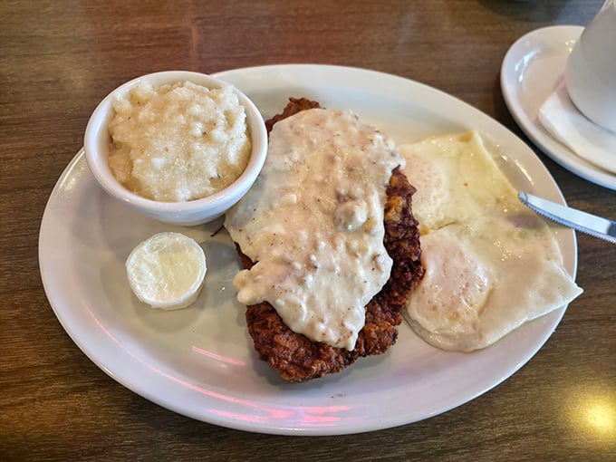 Country fried steak swimming in creamy gravy—the kind of dish that makes you want to call your mother and apologize for ever complaining about her cooking.