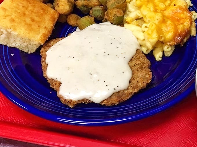 Country fried steak smothered in pepper gravy alongside mac and cheese—Southern comfort that hugs you from the inside.