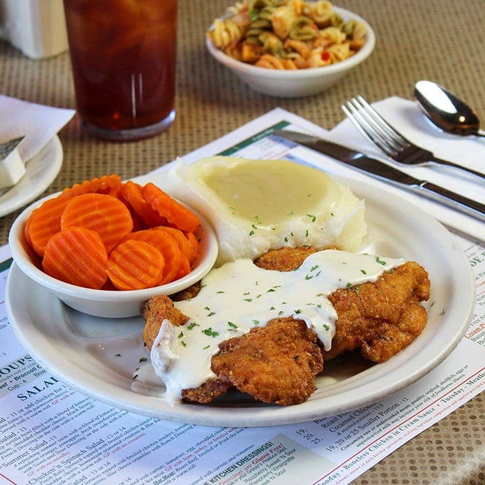 Country fried steak smothered in gravy with sides that make you understand why Midwesterners are so darn friendly—they're well-fed.