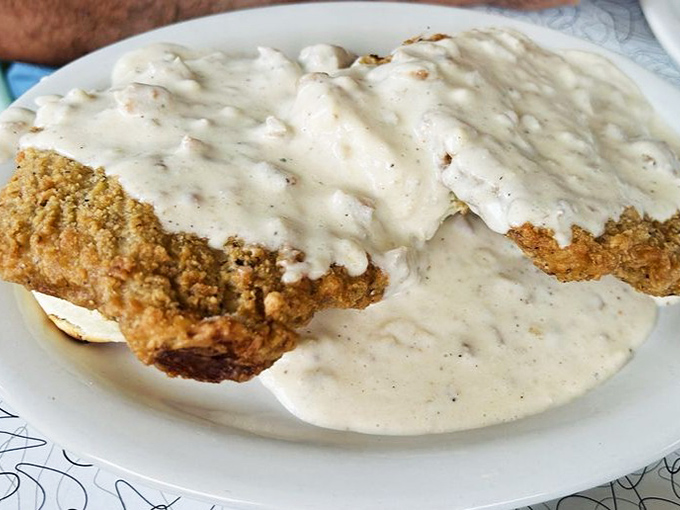 Country fried steak swimming in creamy gravy—the kind of dish that makes you want to hug the chef and then take a well-deserved nap.