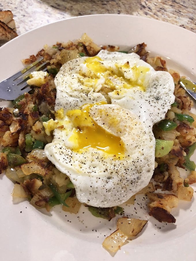 Home fries with perfectly runny eggs – the breakfast equivalent of hitting all green lights on your morning commute.