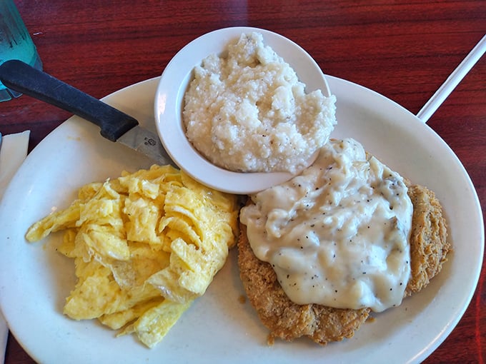Country fried perfection with gravy, eggs, and grits – the holy trinity of Southern breakfast that makes Yankees weep with joy.