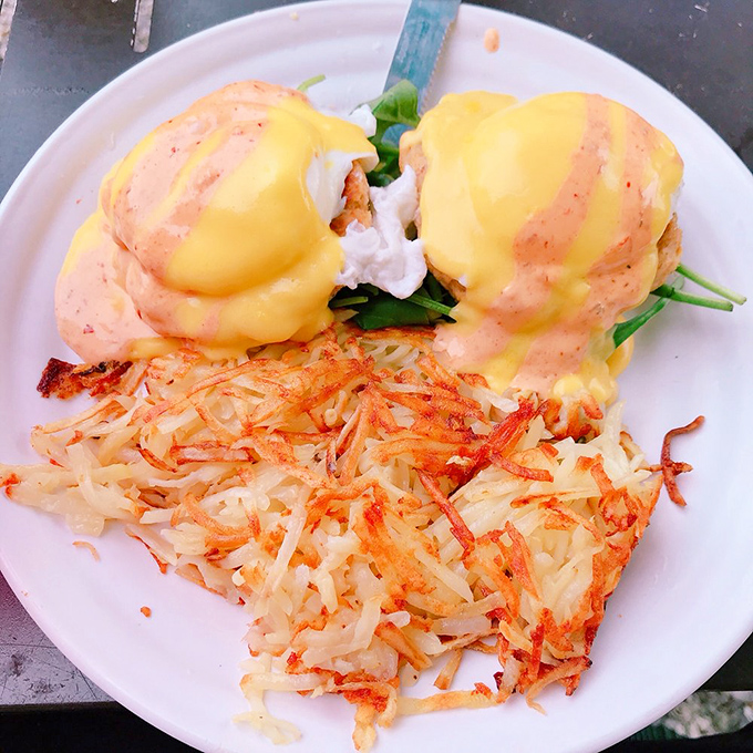 Benedict perfection: poached eggs perched atop English muffins, draped in hollandaise that cascades like a yellow waterfall of happiness.