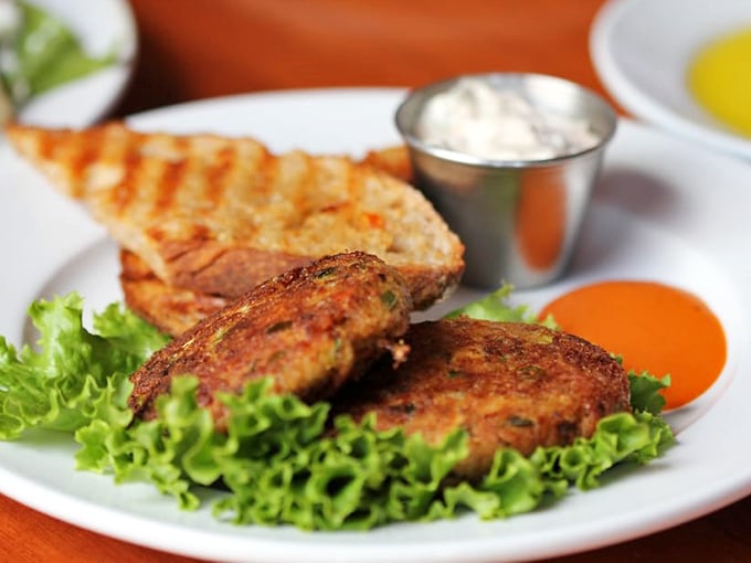 These crab cakes aren't just good—they're "text your foodie friends immediately" good. Crispy exterior, tender interior, and sauces that deserve their own fan club.