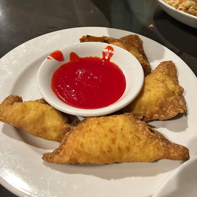 Golden-fried crab rangoon triangles with sweet-hot dipping sauce—the kind of appetizer that makes you consider canceling your entrée altogether.