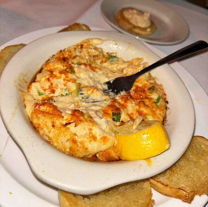 Golden-brown with melted cheese that stretches with each scoop—this isn't just a dip, it's the opening act that threatens to upstage even the headlining steaks.